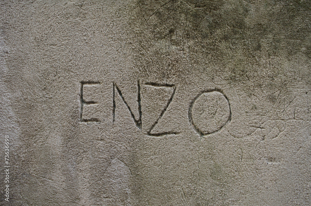 Enzo, masculine italian name carved on a wall Stock Photo | Adobe Stock