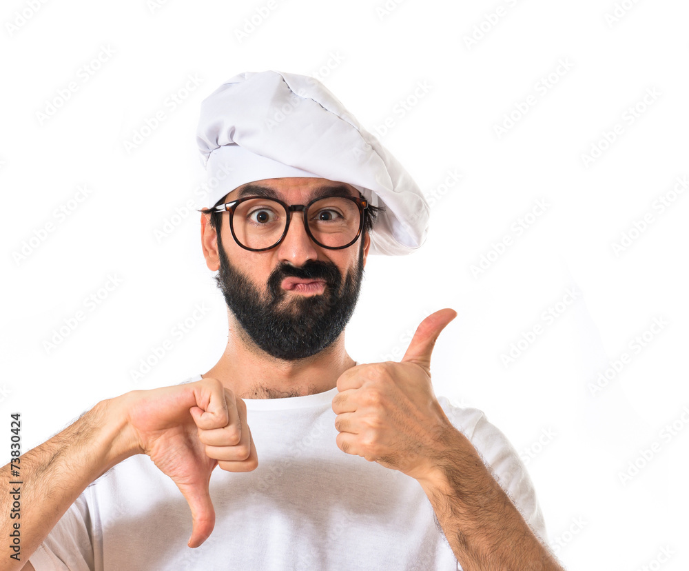 chef making a good-bad sign over white background Stock Photo | Adobe Stock