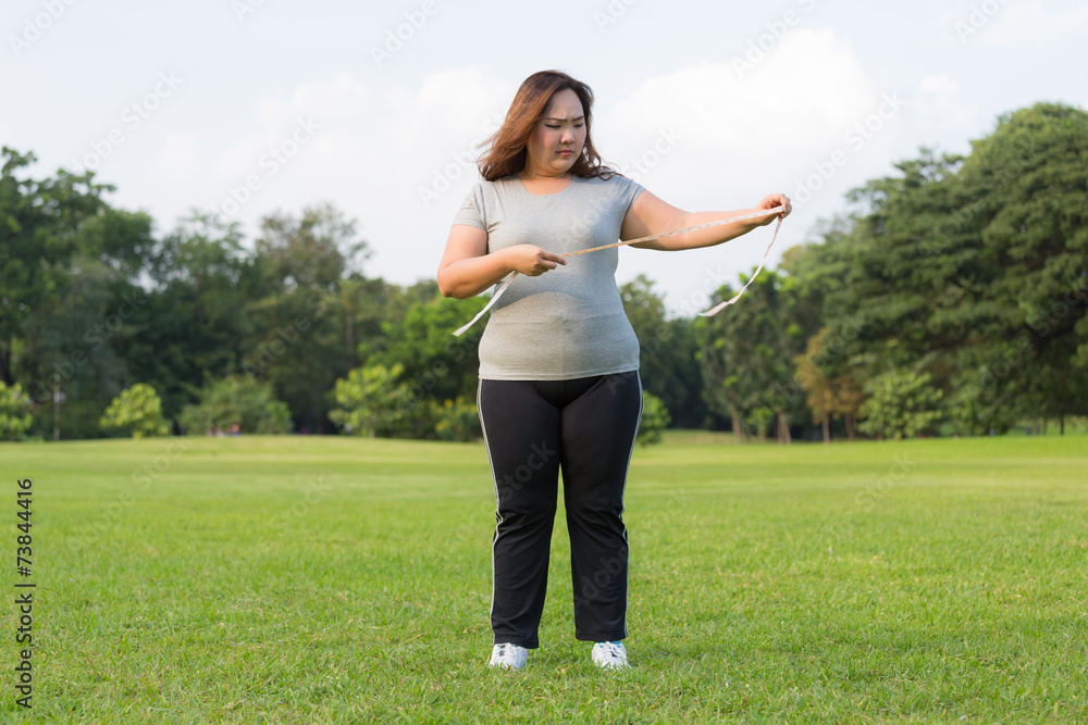 obese women is worrying about her overweight Stock Photo | Adobe Stock