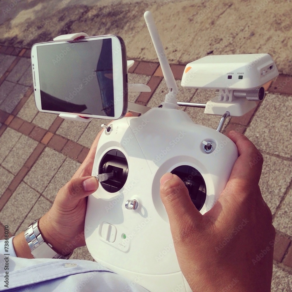 Controlling a remote helicopter drone Stock Photo | Adobe Stock