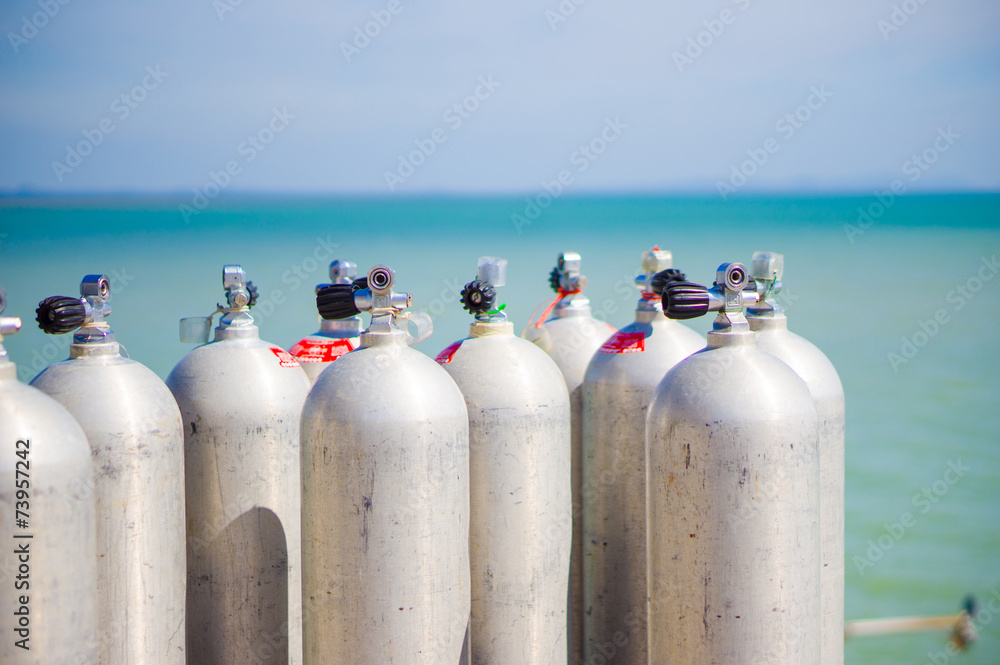Metal scuba diving oxygen tanks on tropical beach pier Stock Photo ...