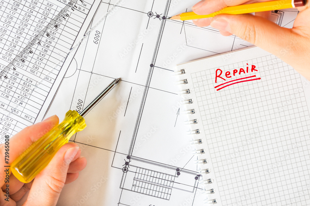 Draw a plan of home renovation, hand holding a screwdriver and p Stock ...