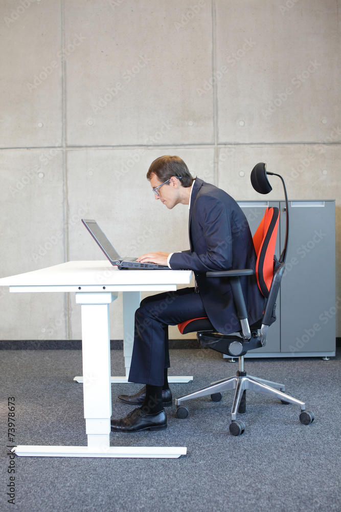 short-sighted business man bad sitting posture at laptop . Stock Photo ...