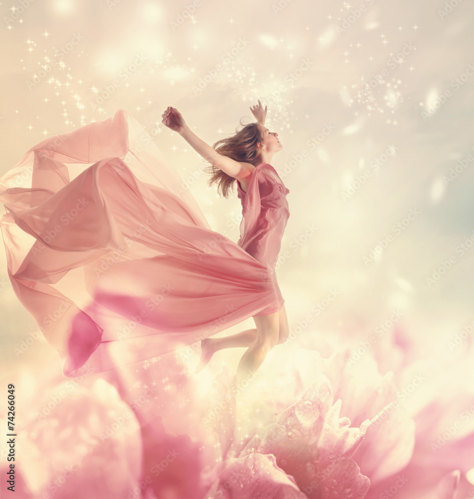 Beautiful young woman jumping on a giant flower Stock Photo | Adobe Stock