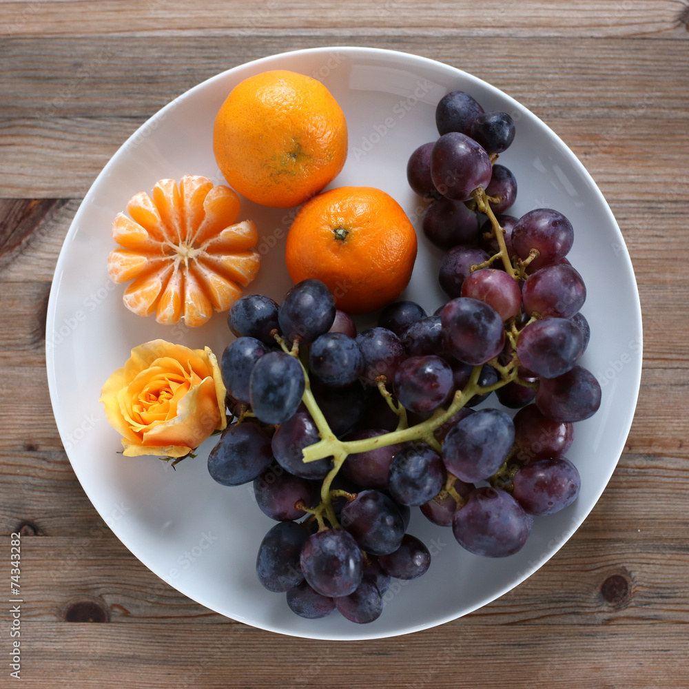Blue grapes and mandarin oranges Stock-Foto | Adobe Stock