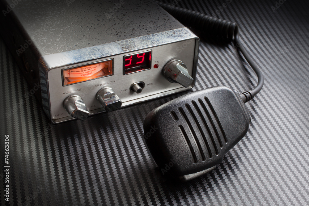 CB radio with microphone that is running on a carbon fiber surface ...