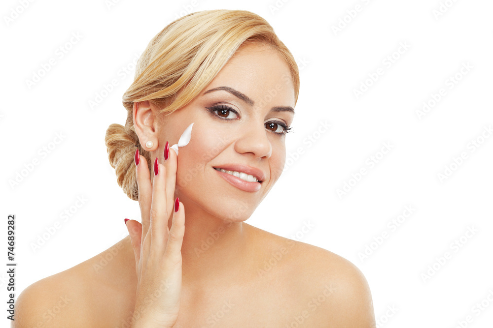 Beautiful face of young woman applying cream - isolated Stock Photo ...