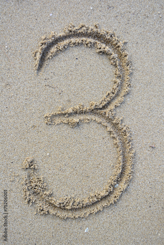 Number three written on a sand beach. Stock Photo | Adobe Stock