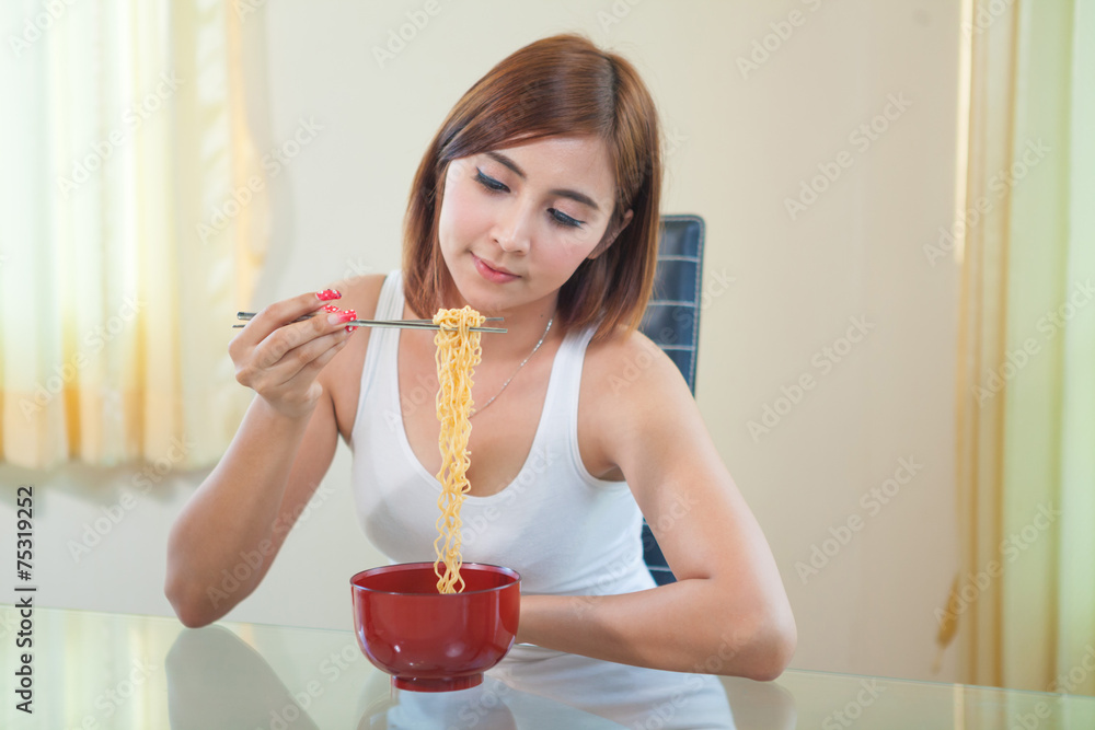 Young girl eating ramen noodles Stock Photo | Adobe Stock