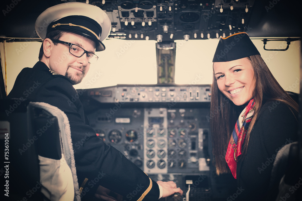 Pilot and stewardess sitting in an airplane cabin Stock-Foto | Adobe Stock