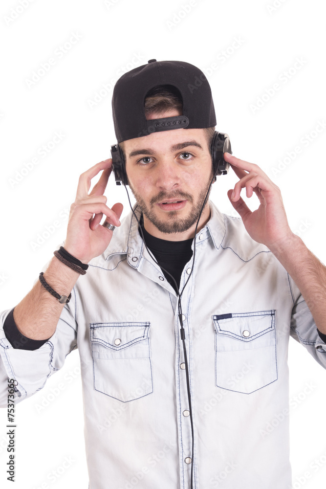 Handsome young guy listening to music wearing black cap and usin Stock ...