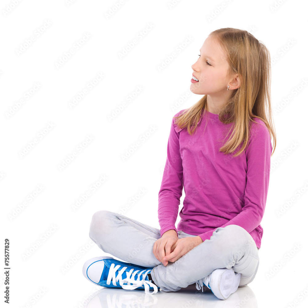 Little girl sitting with legs crossed Stock-Foto | Adobe Stock