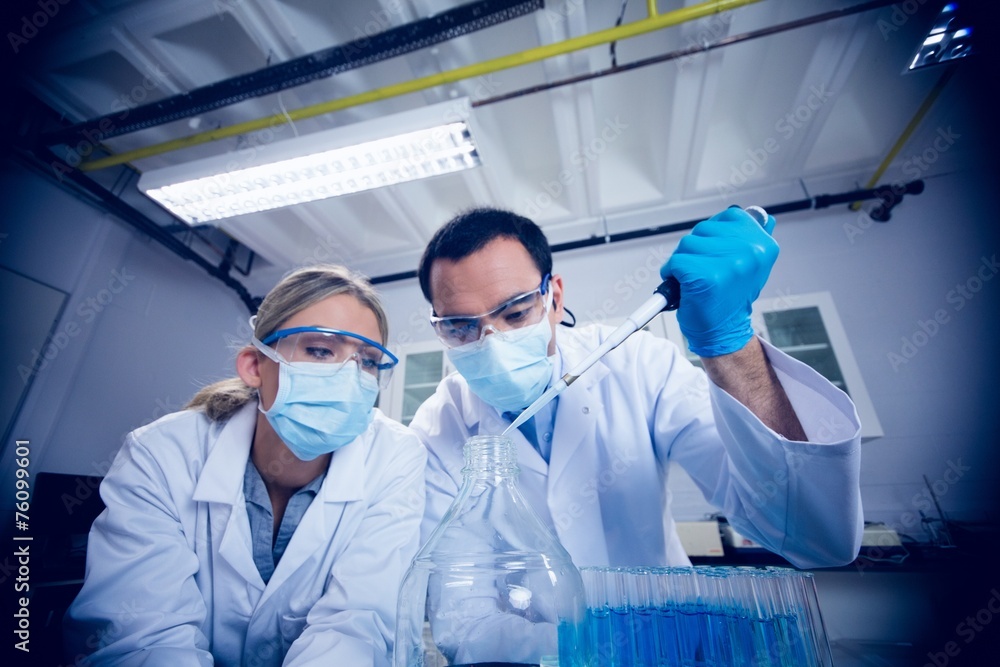 Science students using pipette to fill test tubes Stock Photo | Adobe Stock