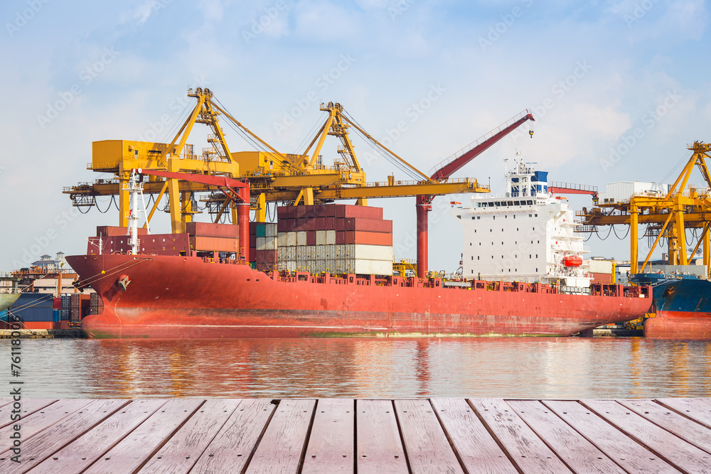 Gantry crane loading and unloading cargo container from cargo ship at ...