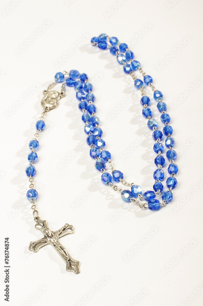 Blue rosary isolated on the bright background Stock-Foto | Adobe Stock