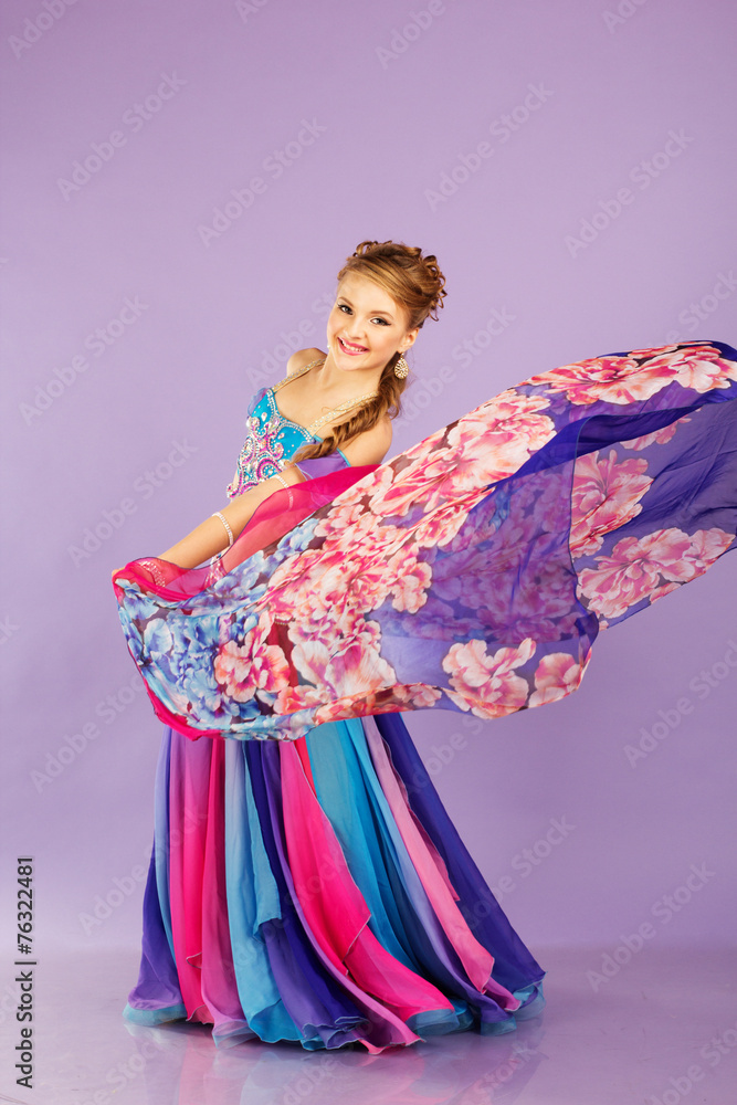 Beautiful belly dancer wearing a purple costume Stock Photo | Adobe Stock