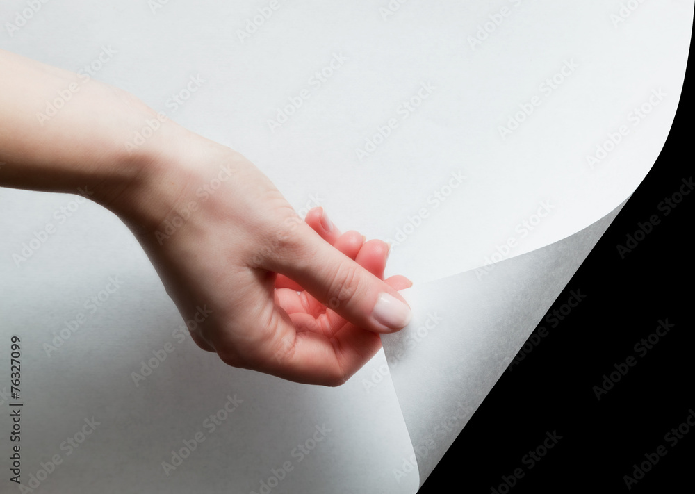 Hand pulling a paper corner to uncover, reveal something Stock Photo ...