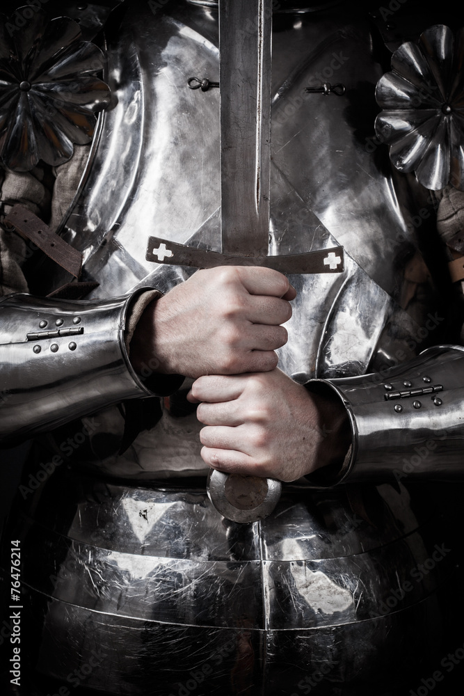 knight wearing armor and holding two-handed sword Stock Photo | Adobe Stock