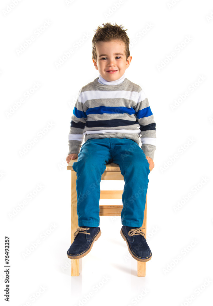 Kid sitting on chair Stock Photo | Adobe Stock