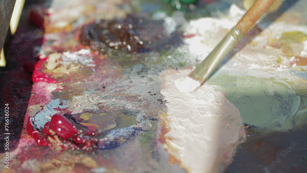 painter mixes with the brush colors in his palette Stock Video | Adobe ...