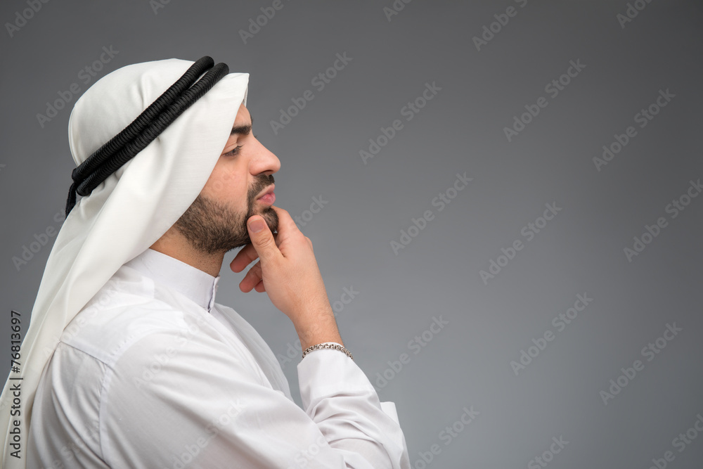 Arab man thinking hard with hand on his face Stock Photo | Adobe Stock