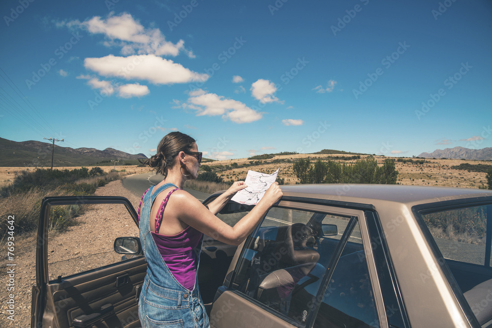 Woman standing next to old car reading a map. Swartberg. Western Stock ...