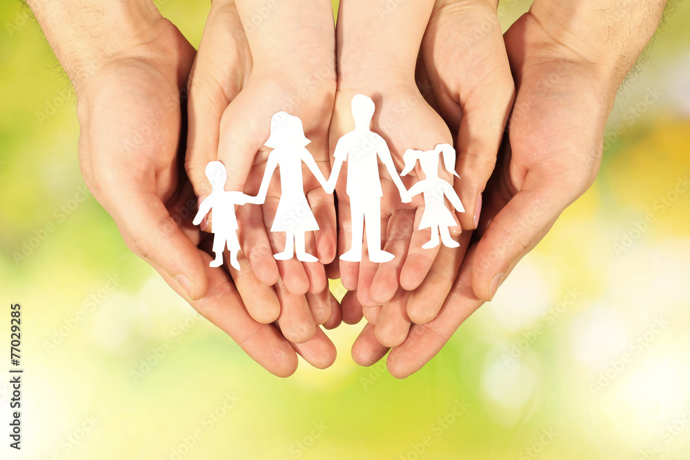 Paper family in hands on bright background Stock Photo | Adobe Stock