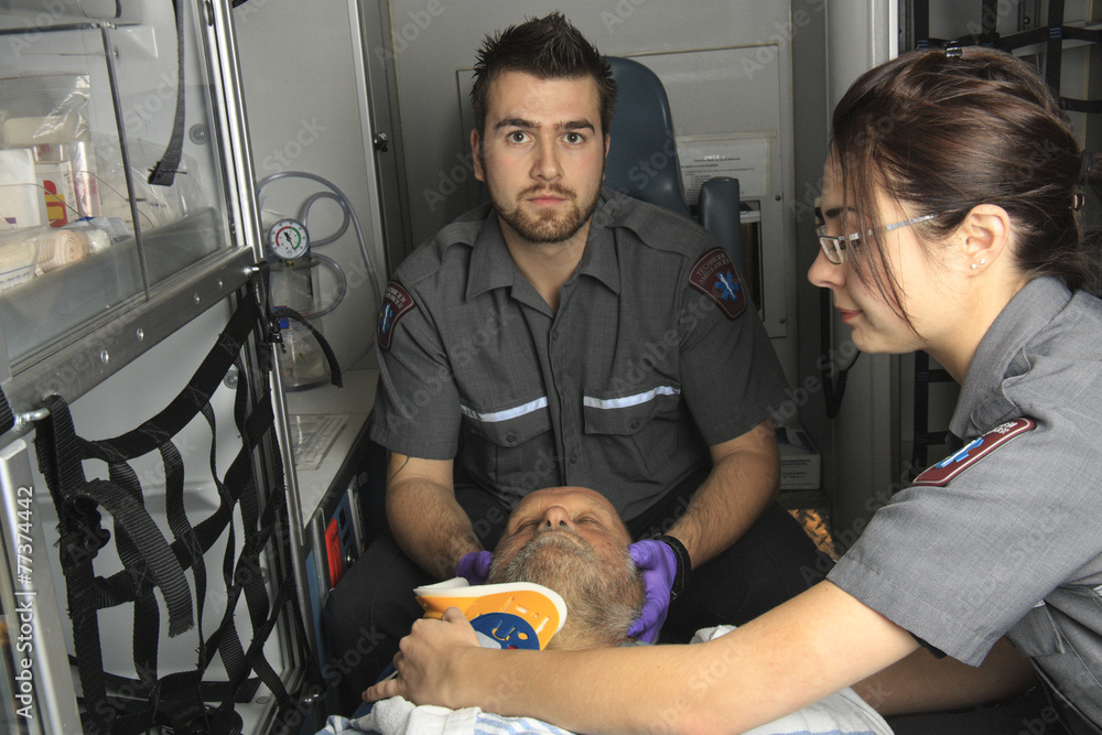 professional paramedics giving unconscious young woman first aid Stock ...