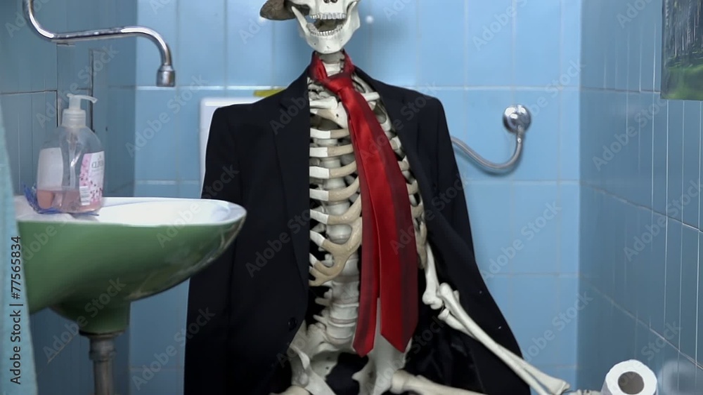skeleton in business clothes sitting on the toilet Stock Video | Adobe ...