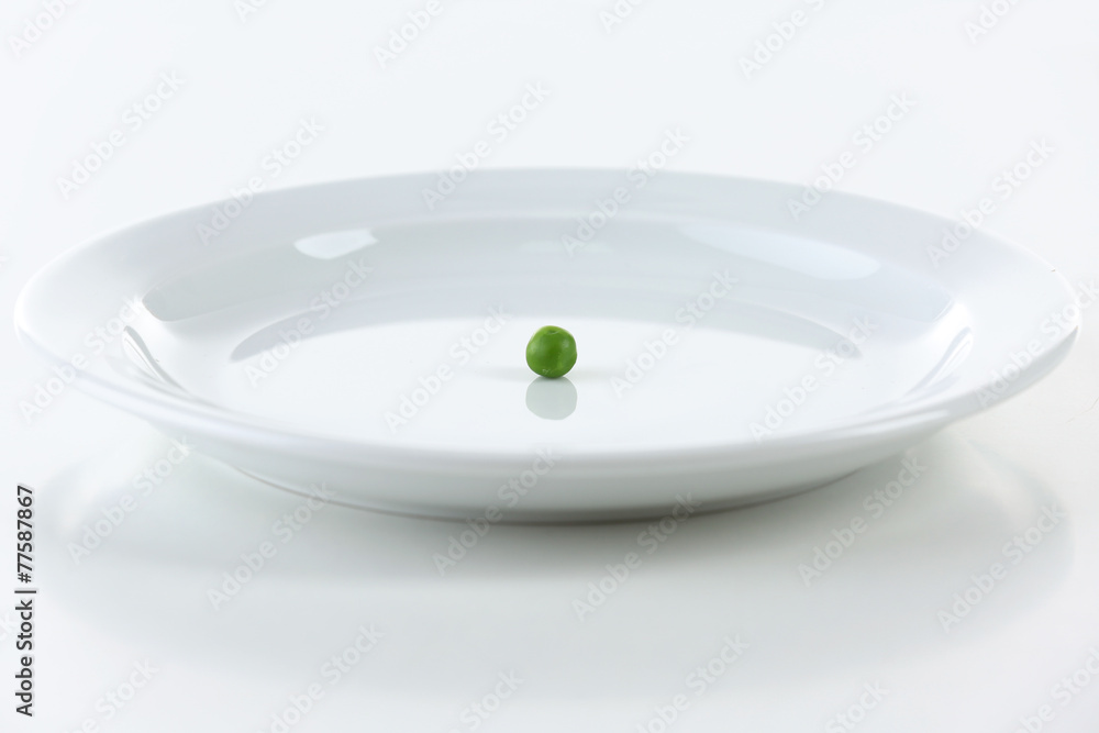 One pea on plate isolated on white Stock Photo | Adobe Stock