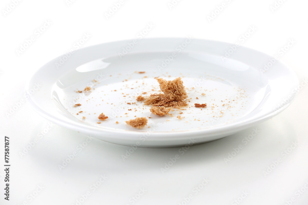 Bread crumbs on plate isolated on white Stock Photo | Adobe Stock