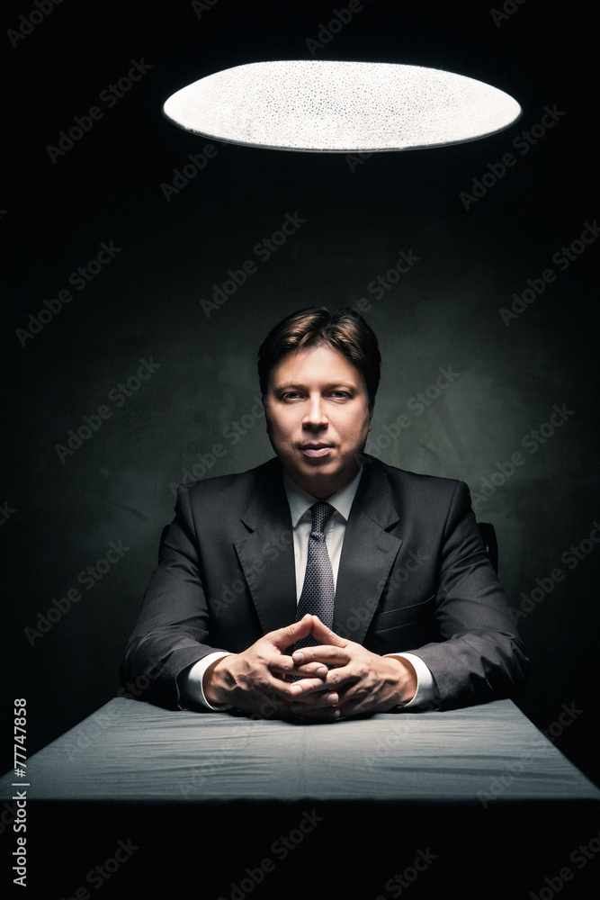 Man wearing suit in dark room illuminated by lamp Stock Photo | Adobe Stock