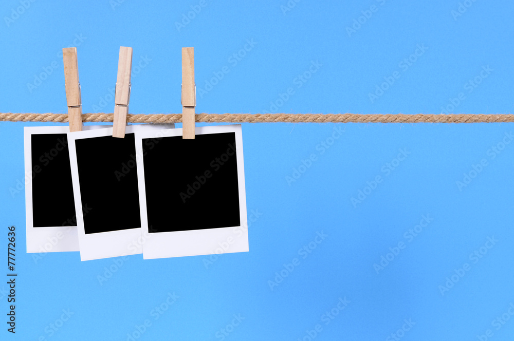 Several blank polaroid style photo frame prints on a rope string or ...