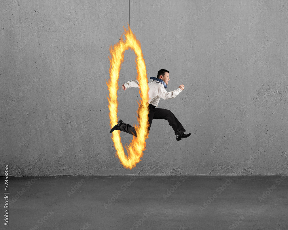 Man jumping through fire hoop with concrete wall Stock Photo | Adobe Stock