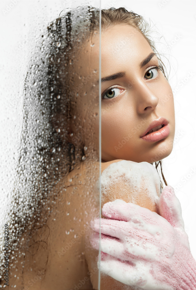 Beautiful woman washing her body shower gel. Stock Photo | Adobe Stock