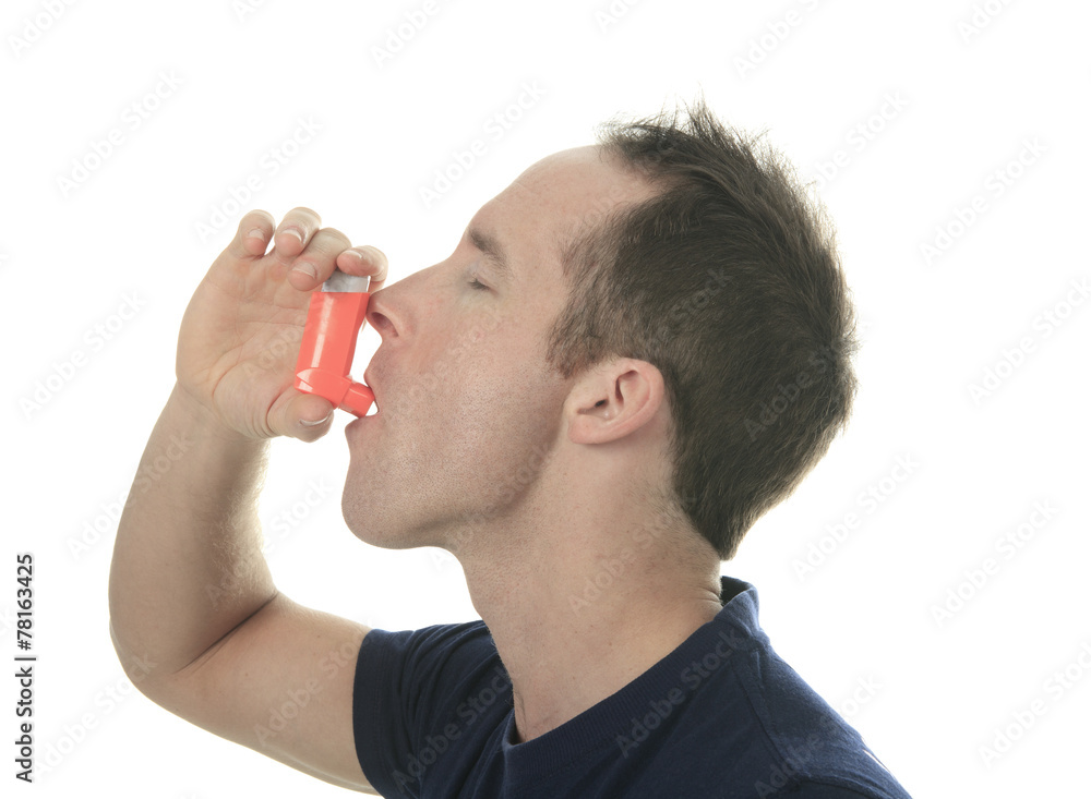 Young man using an asthma inhaler as prevention Stock Photo | Adobe Stock