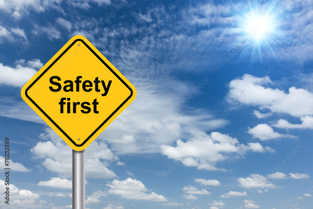 safety first sign banner and clouds blue sky background Stock Photo ...
