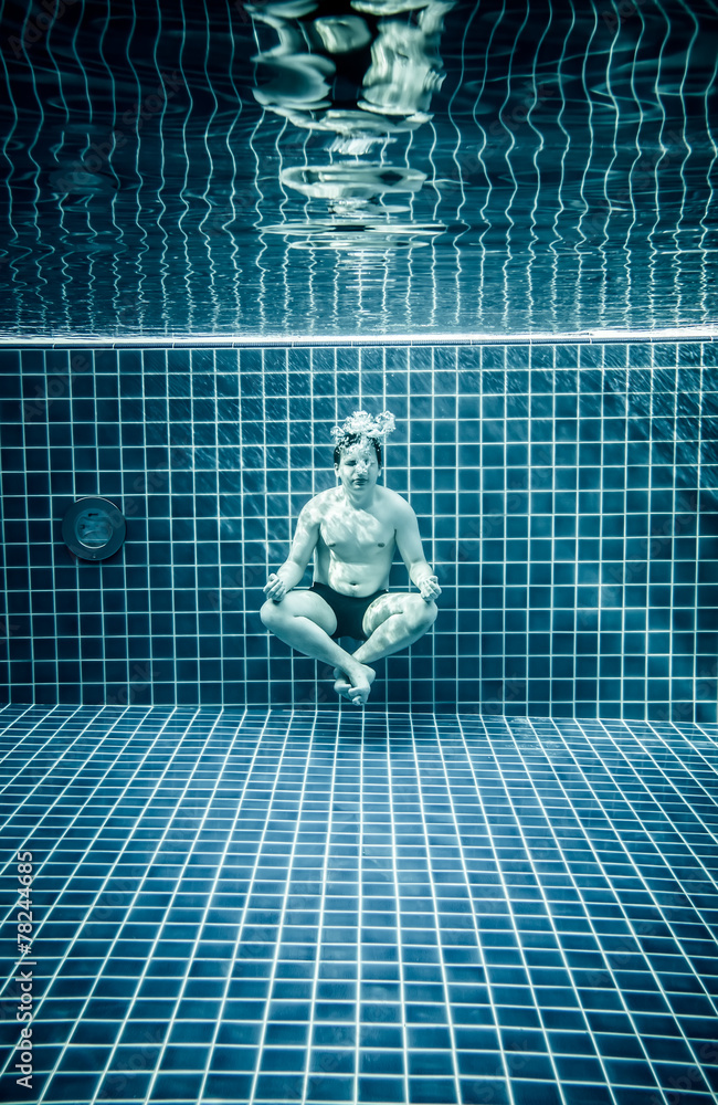 Man under water in a swimming pool to relax in the lotus positio Stock ...