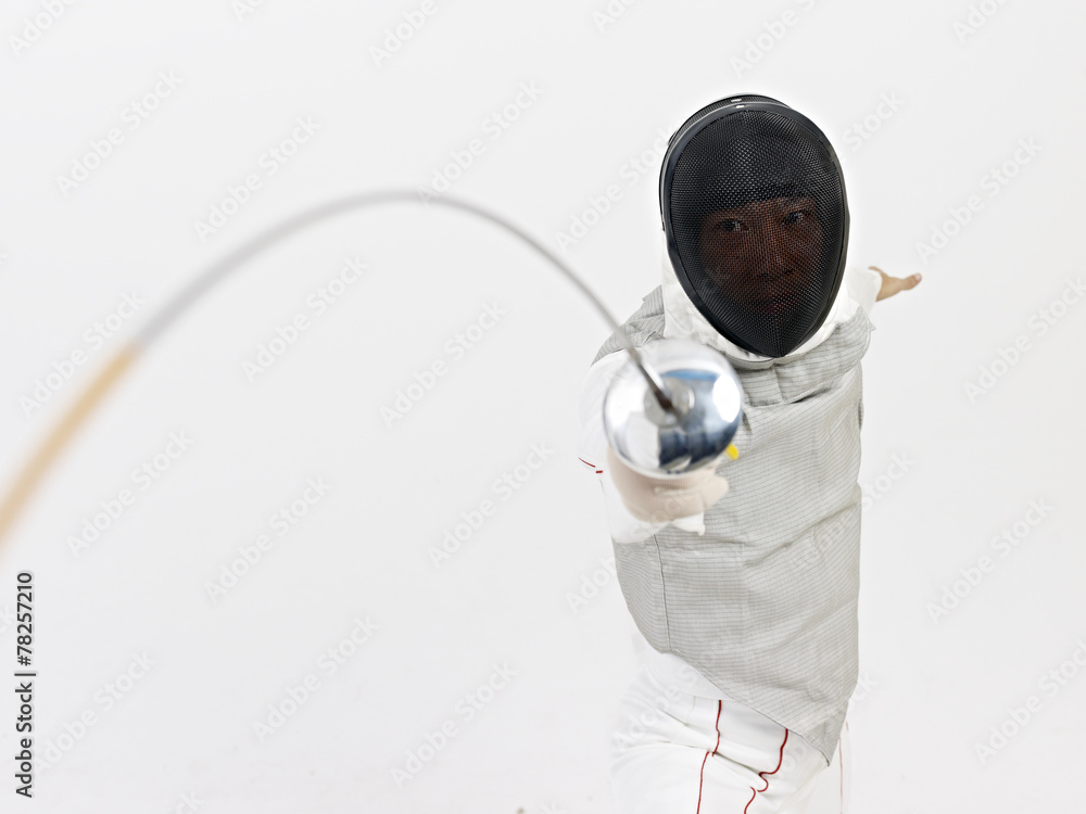 fencer in action Stock Photo | Adobe Stock
