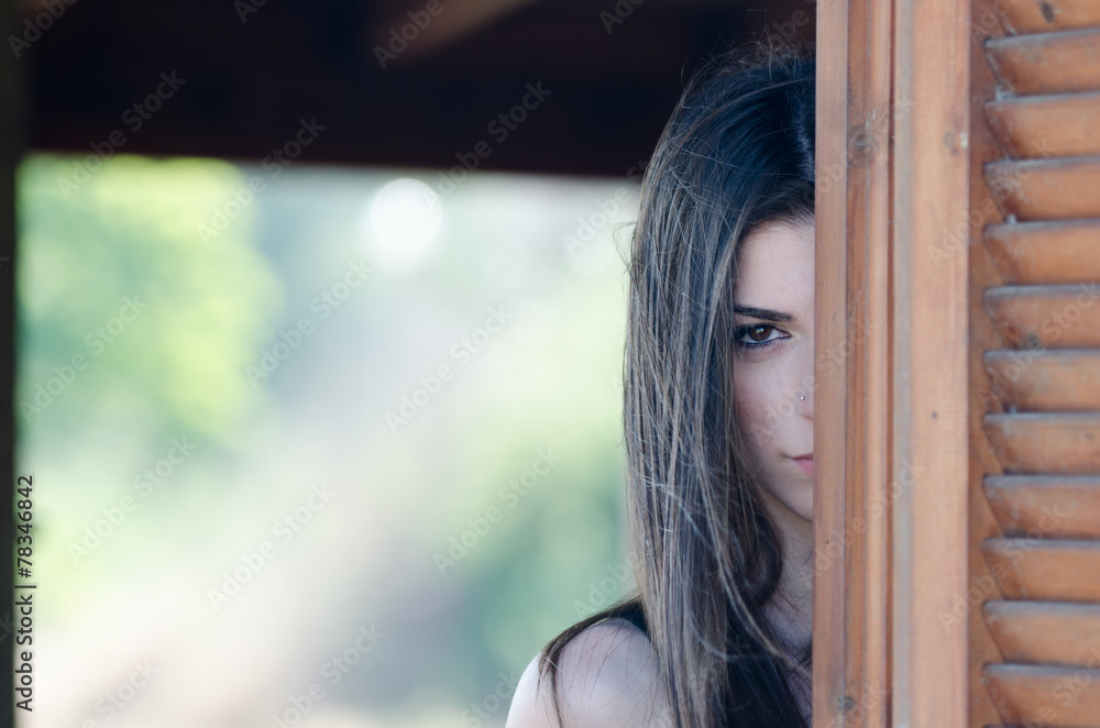 Lady looking out the window of a cabin Stock Photo | Adobe Stock