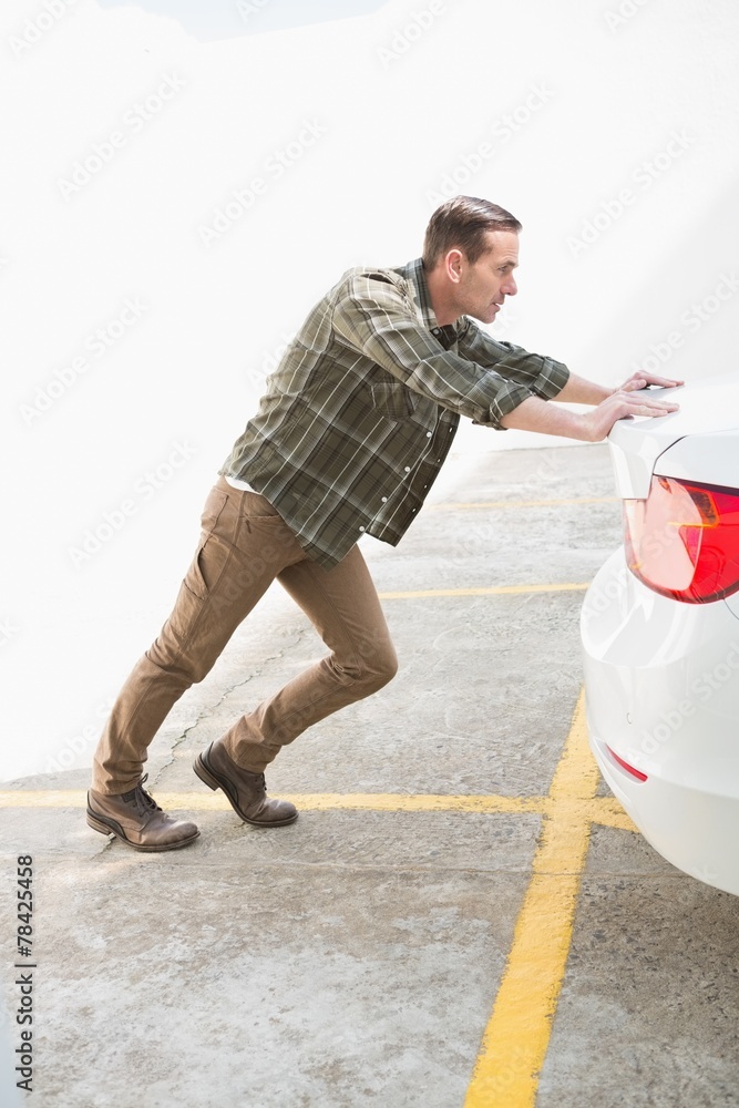 Man pushing his broken down car Stock Photo | Adobe Stock