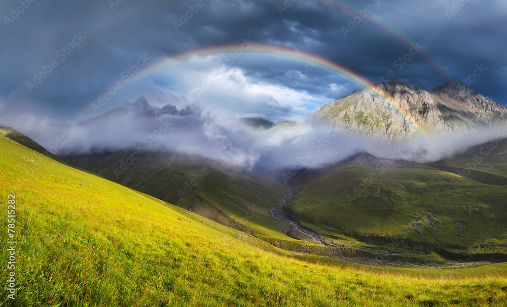 Rainbow in mountain valley during sunset Stock 写真 | Adobe Stock