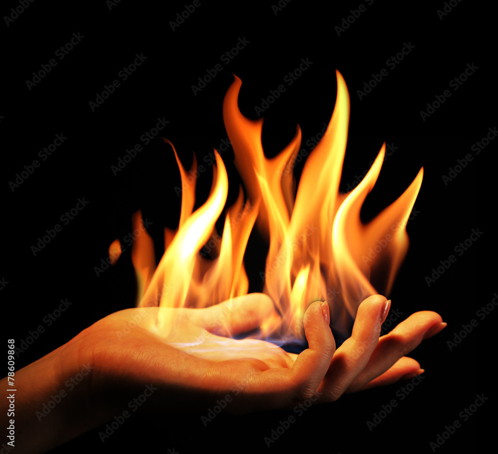 Hand with fire isolated on black Stock Photo | Adobe Stock