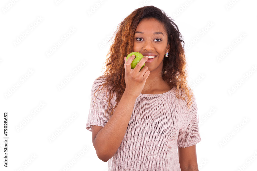 African Americanyoung woman eating one green apple - Black peopl Stock ...