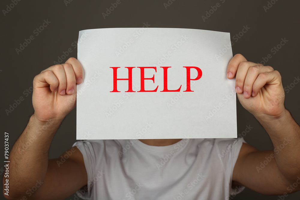 Sheet of paper with Help sign in male hands on dark background Stock ...