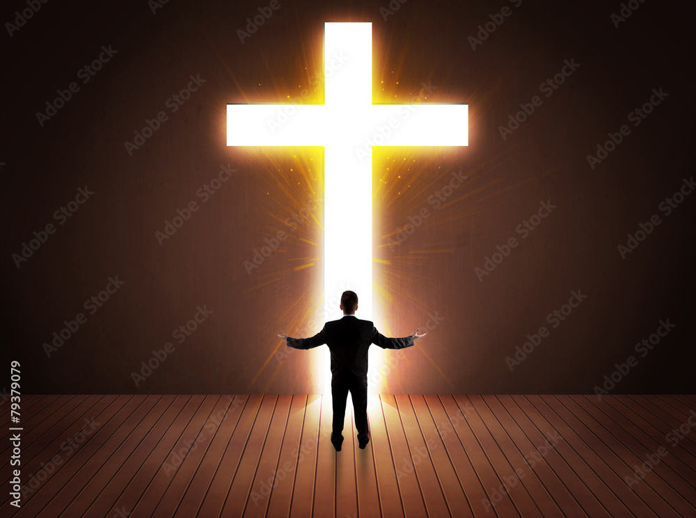 Man looking at bright cross sign Stock Photo | Adobe Stock