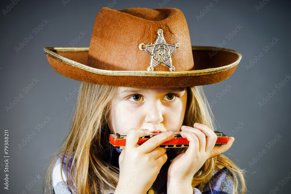Cute little girl playing harmonica Stock Photo | Adobe Stock