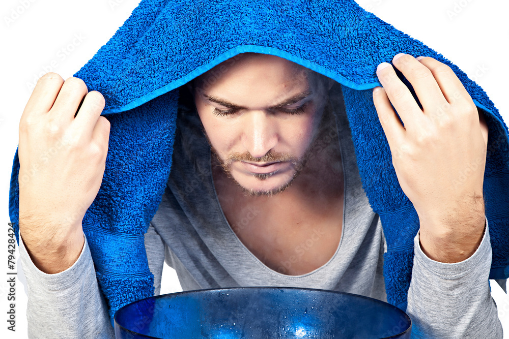 Foto de Young man inhales steam to treat a blocked nose do Stock ...