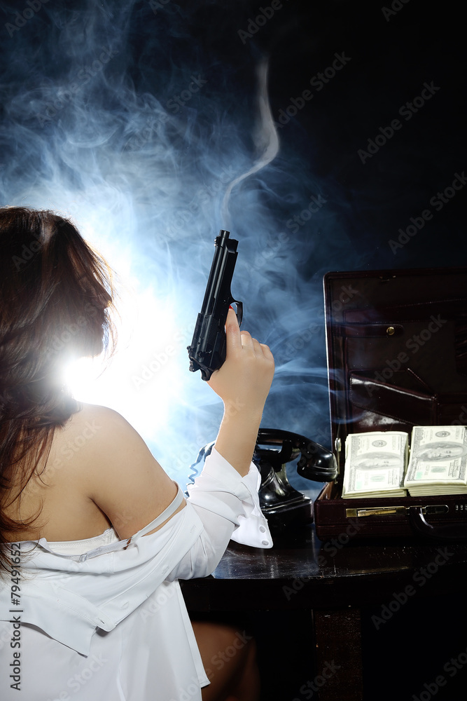 Feminine and sensual Bad girl with gun Stock Photo | Adobe Stock