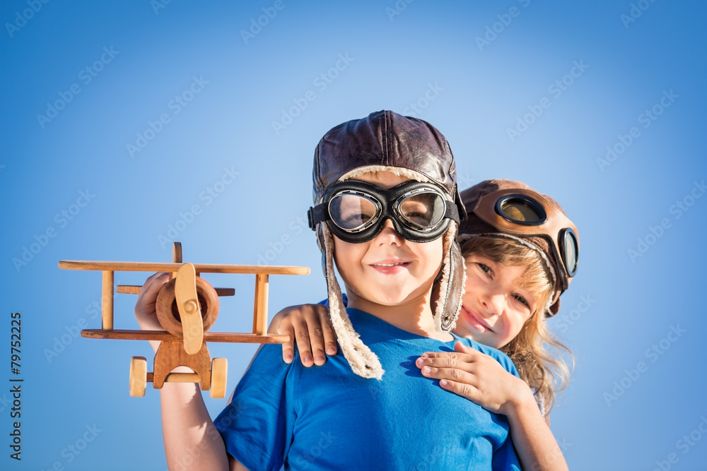 Happy children playing with toy airplane Stock Photo | Adobe Stock